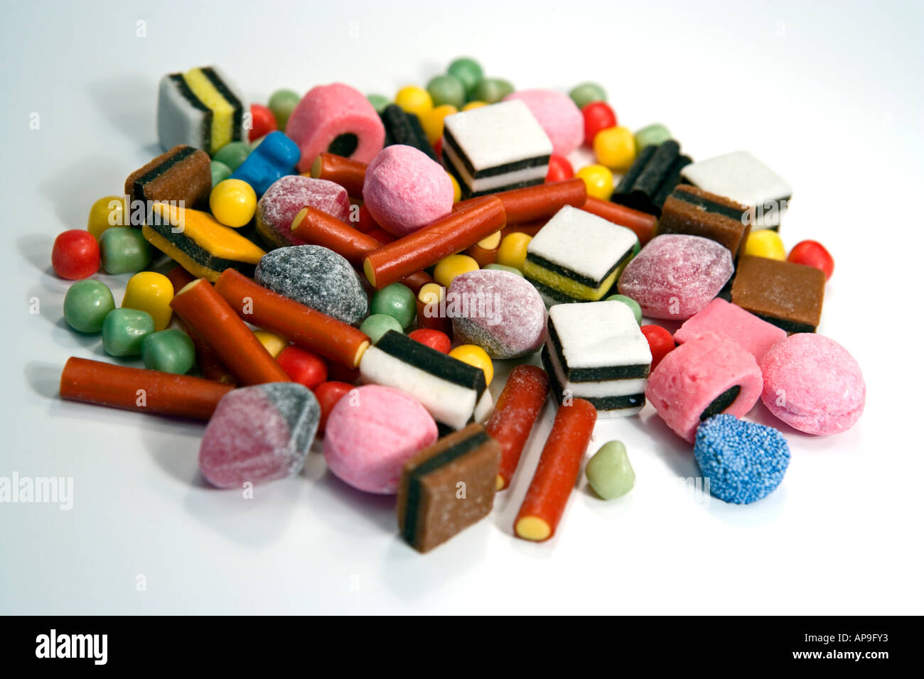 Pile of sweets on white background Stock Photo - Alamy