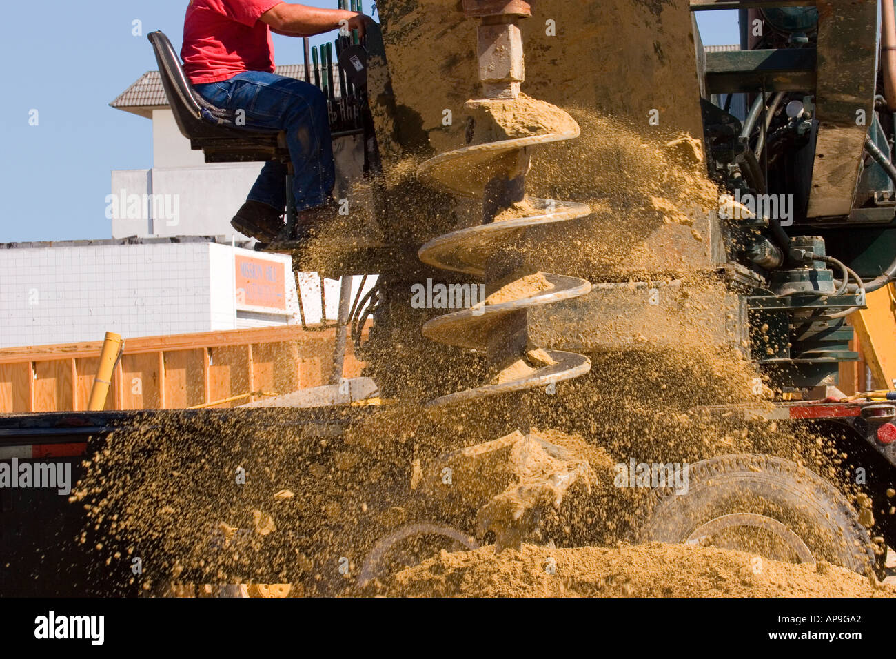 A man operates heavy machinery at a construction site Stock Photo - Alamy