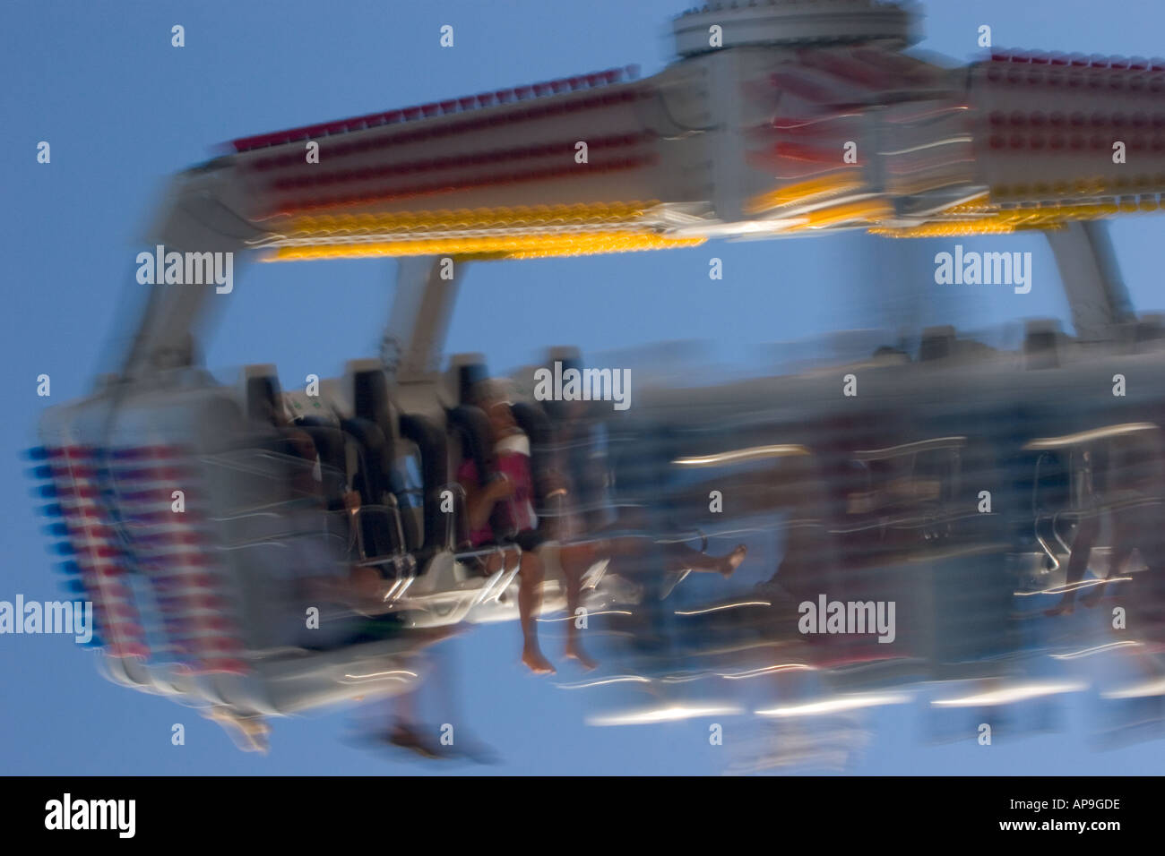 A group of thrill seekers enjoying a high action ride at an amusement ...