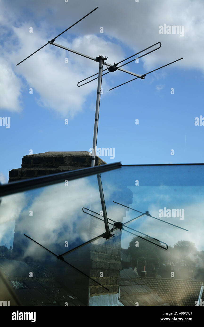 T.v aerial and its reflection on a roof window Stock Photo - Alamy