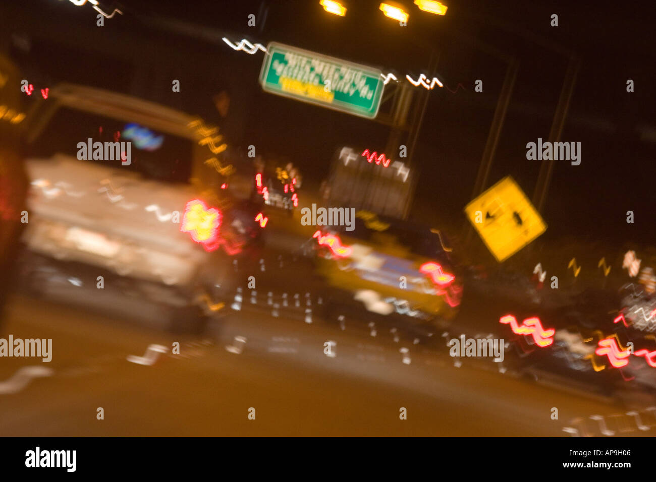 Speeding cars on a highway at night Stock Photo - Alamy