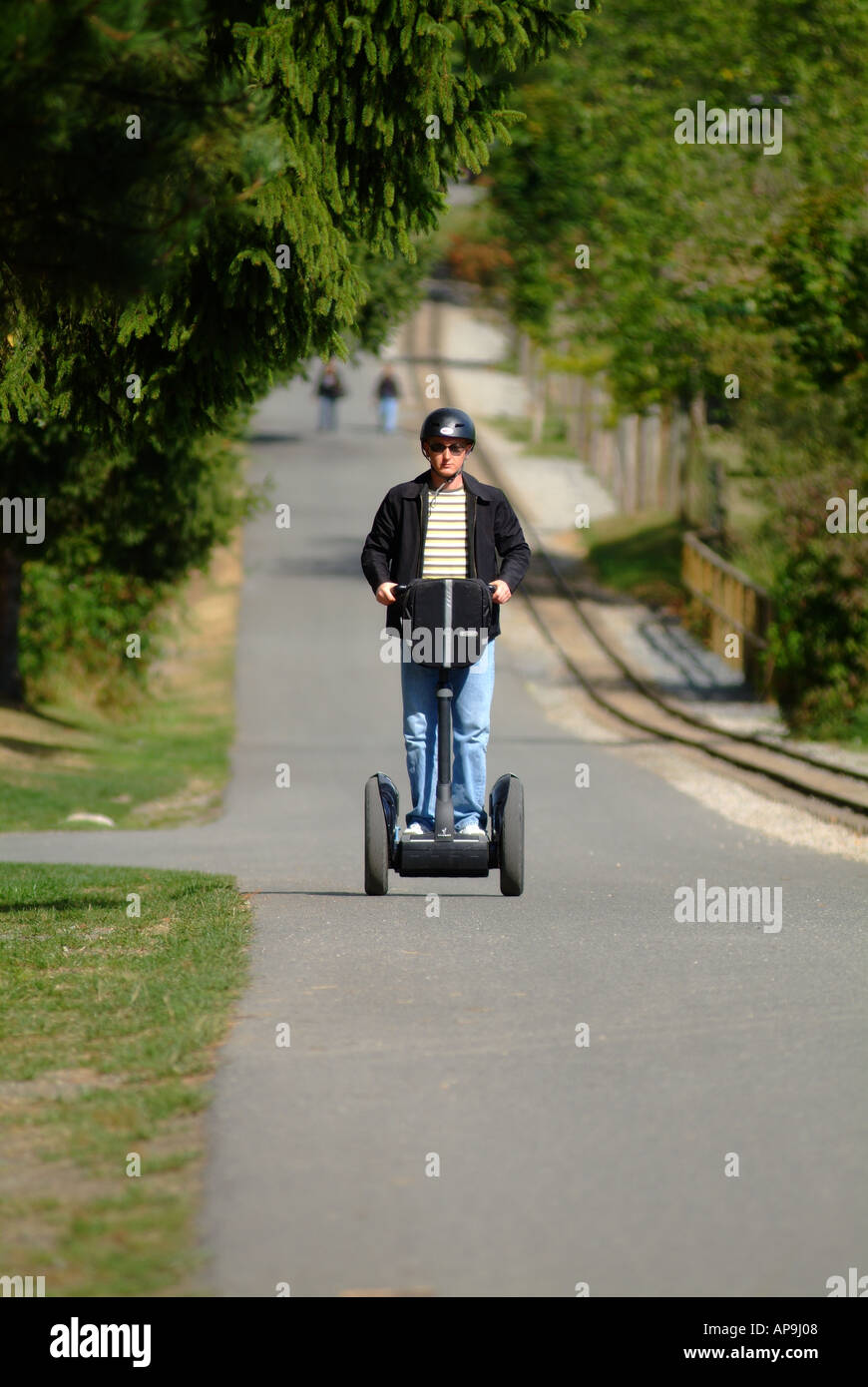 Man riding a Segway people transporter Stock Photo - Alamy