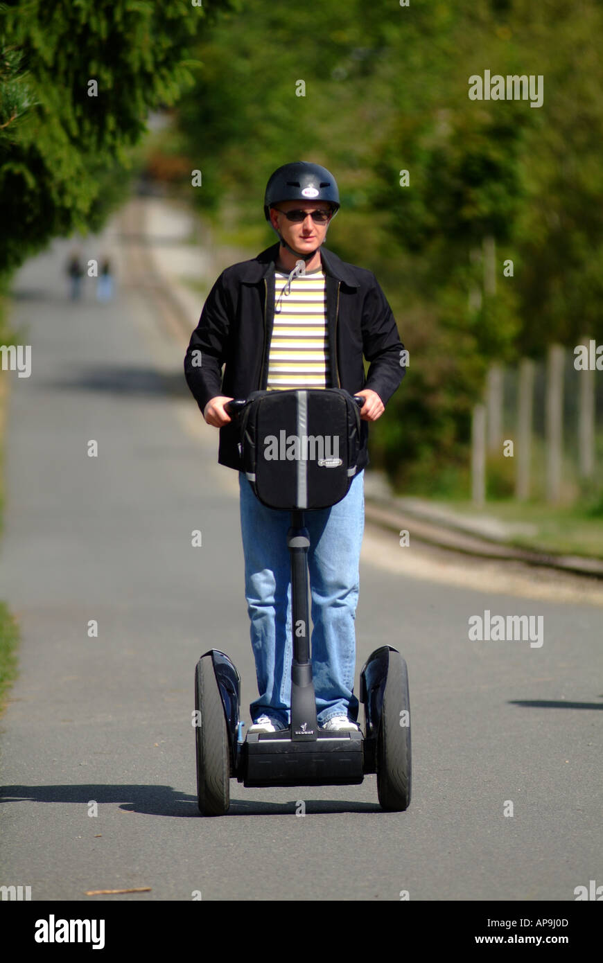 Man riding a Segway people transporter Stock Photo - Alamy