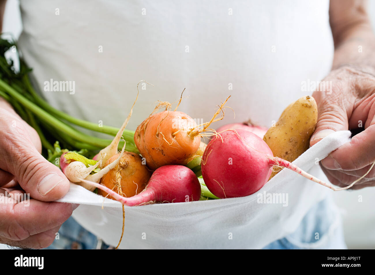 Man carrying vegetables in a t shirt Stock Photo - Alamy