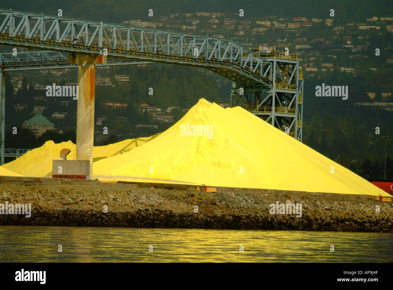 Sulphur piles on dock waiting export by ship Stock Photo - Alamy