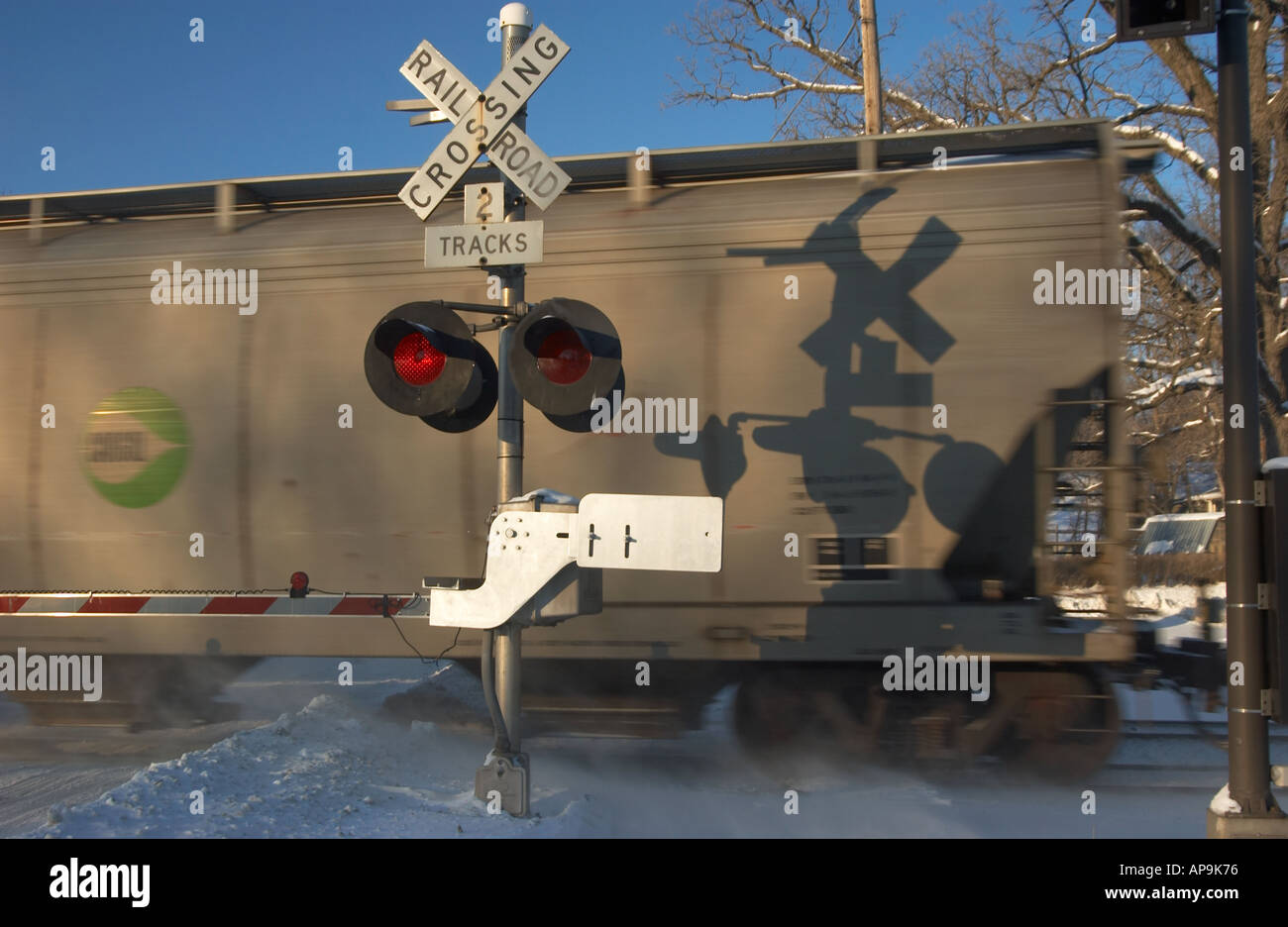 Freight train at a Crossing with a shadow on the train car Stock Photo ...