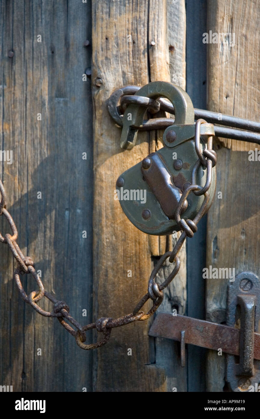 Unlocked old pad lock hanging on door hasp Stock Photo - Alamy