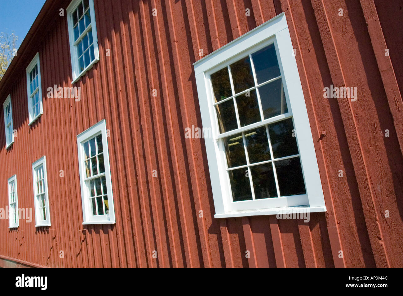 Side of old batton board building shop with white framed windows Stock ...