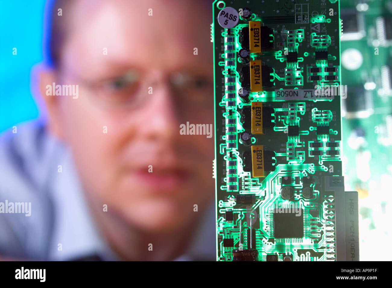Electrical engineer looking at circuit board hi-res stock photography ...