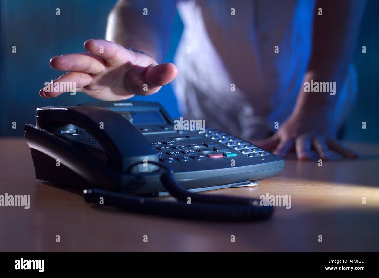 Person reaching for telephone receiver Stock Photo - Alamy