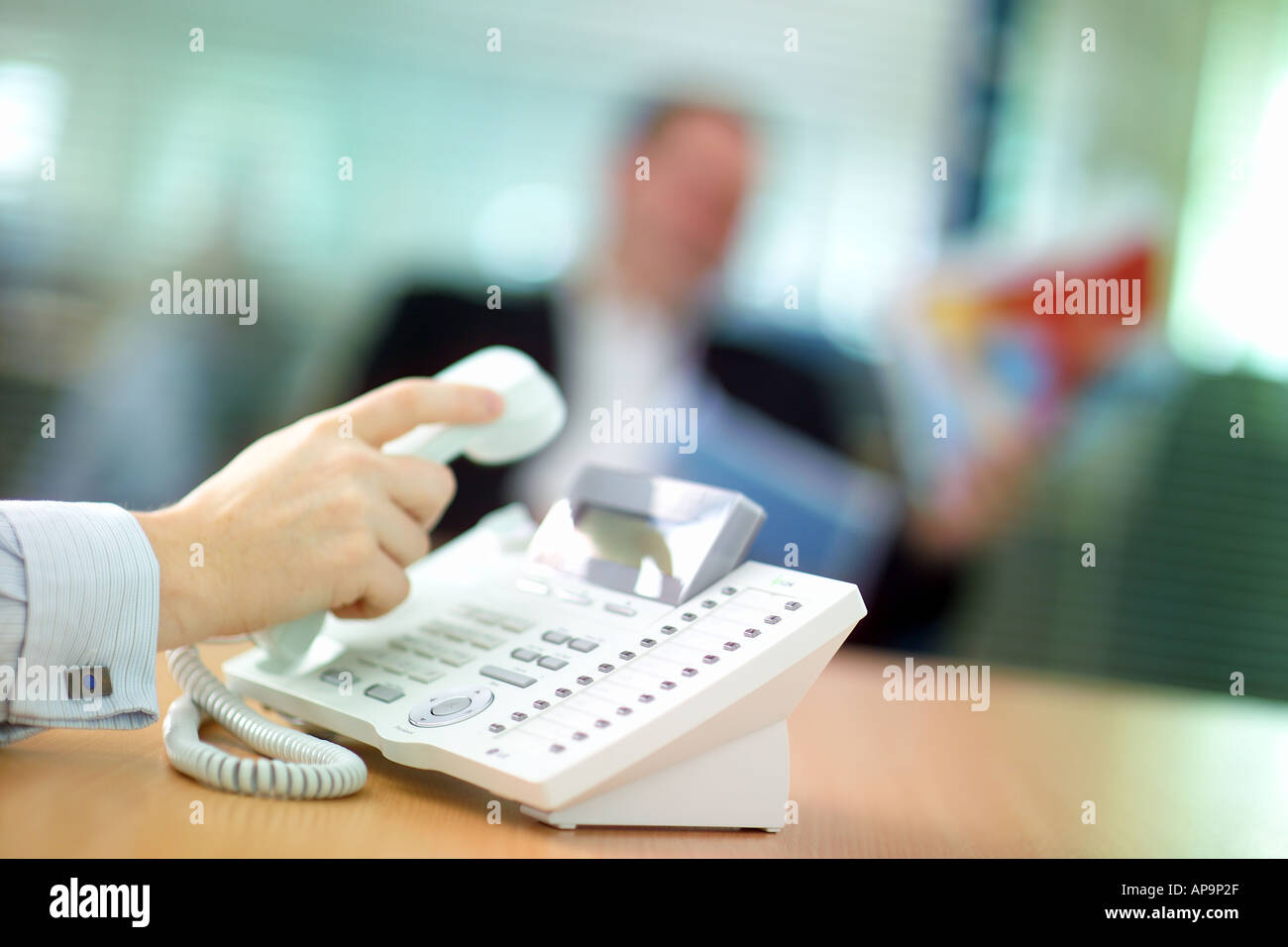 Person answering telephone in office Stock Photo - Alamy