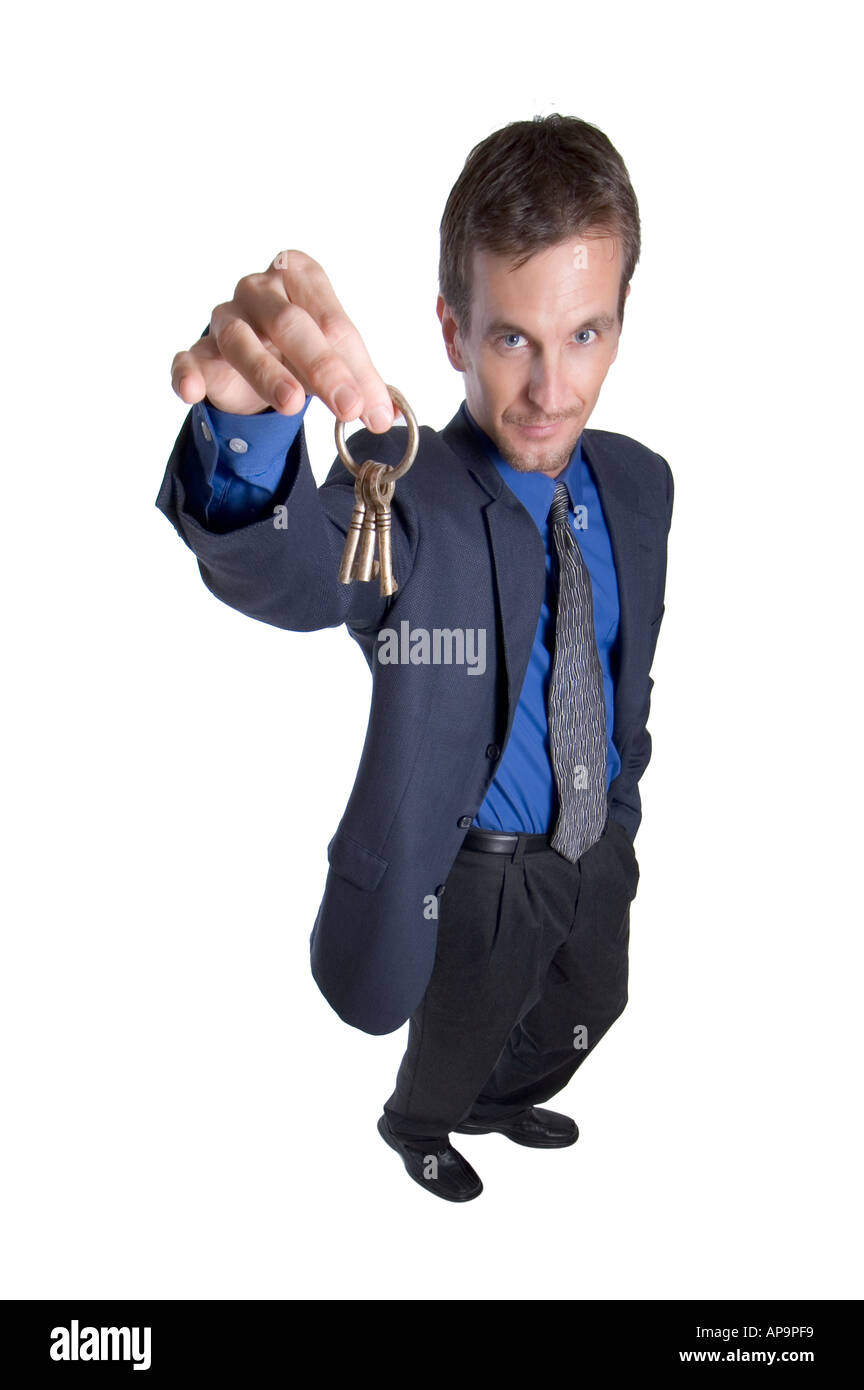 Businessman offering keys Stock Photo - Alamy