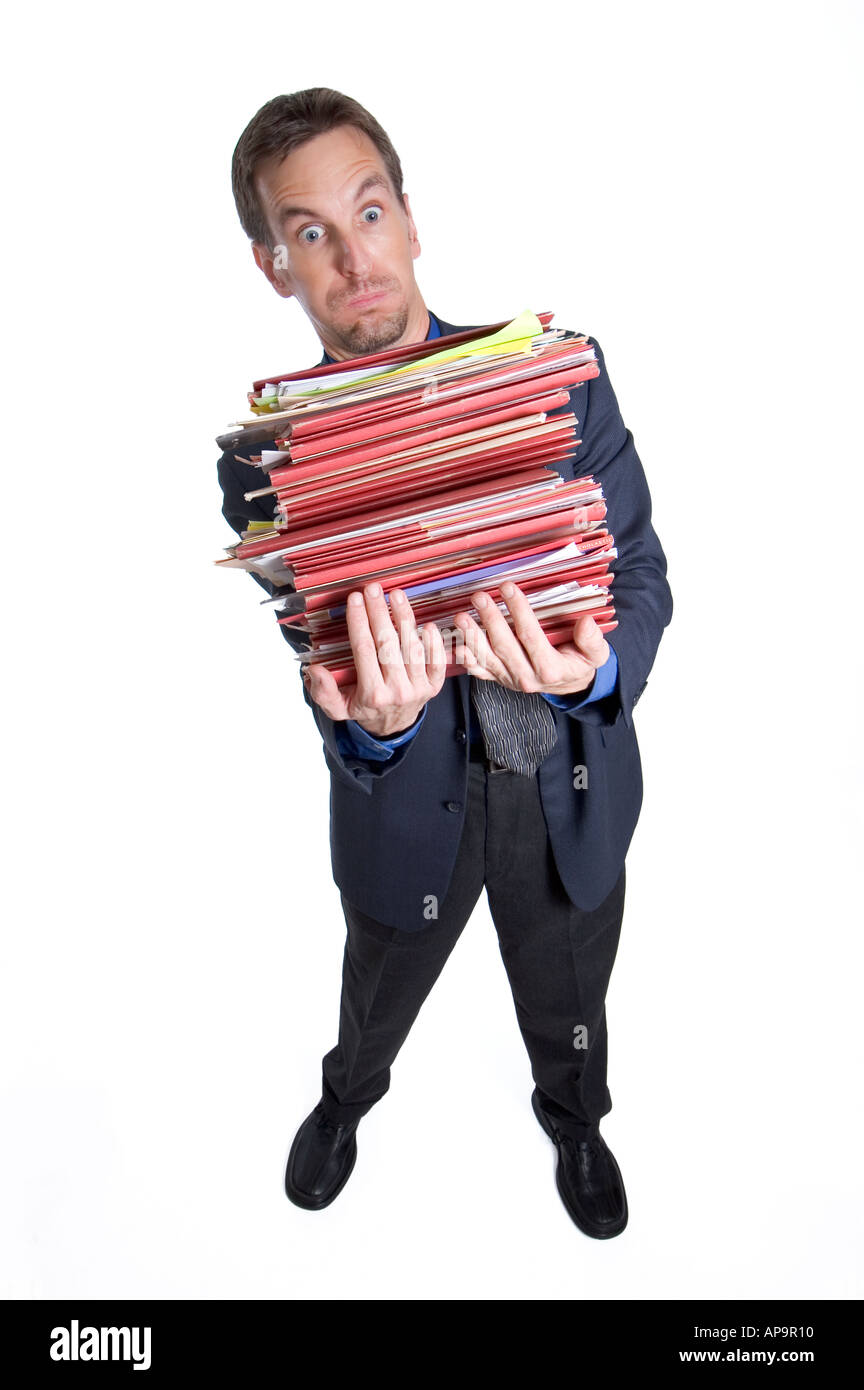 Overworked businessman tipping over from carrying too many folders ...