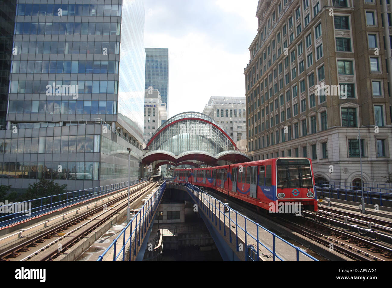 DLR docklands light railway train leaving Canary wharf station London ...