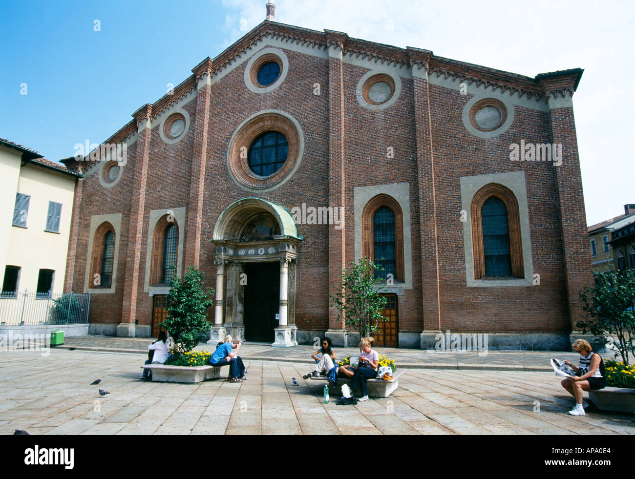 People sitting on benches outside the Santa Maria della Grazie Church ...
