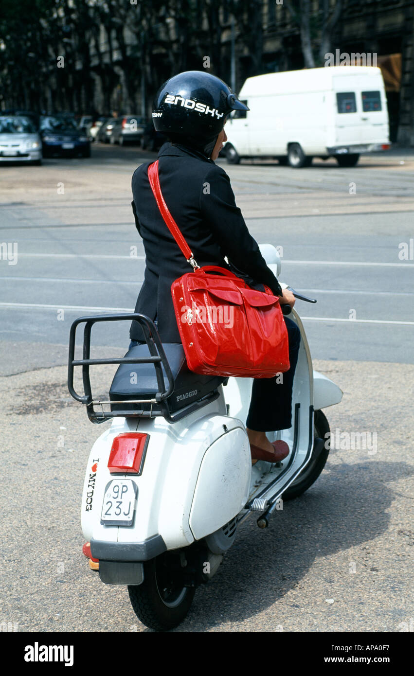 Getting around Milan by moped Italy Stock Photo - Alamy