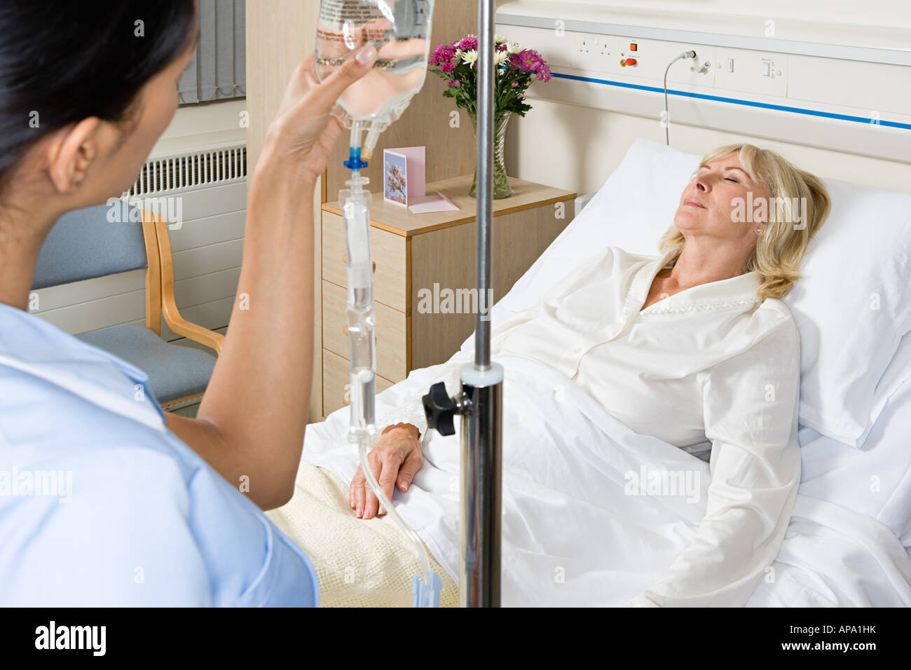 Nurse and sleeping patient Stock Photo - Alamy
