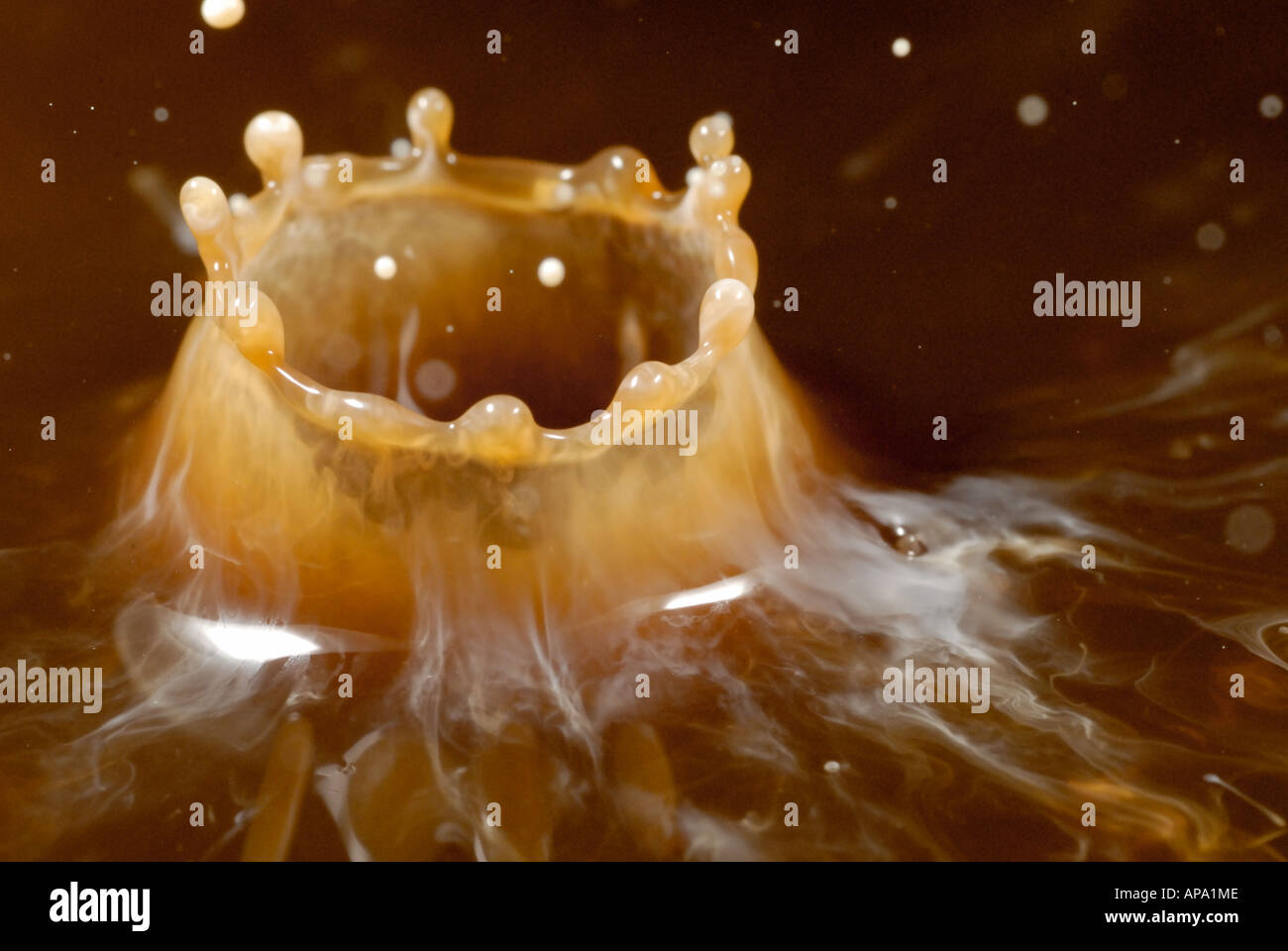 A drop of cream dropped in a cup of coffee Stock Photo - Alamy