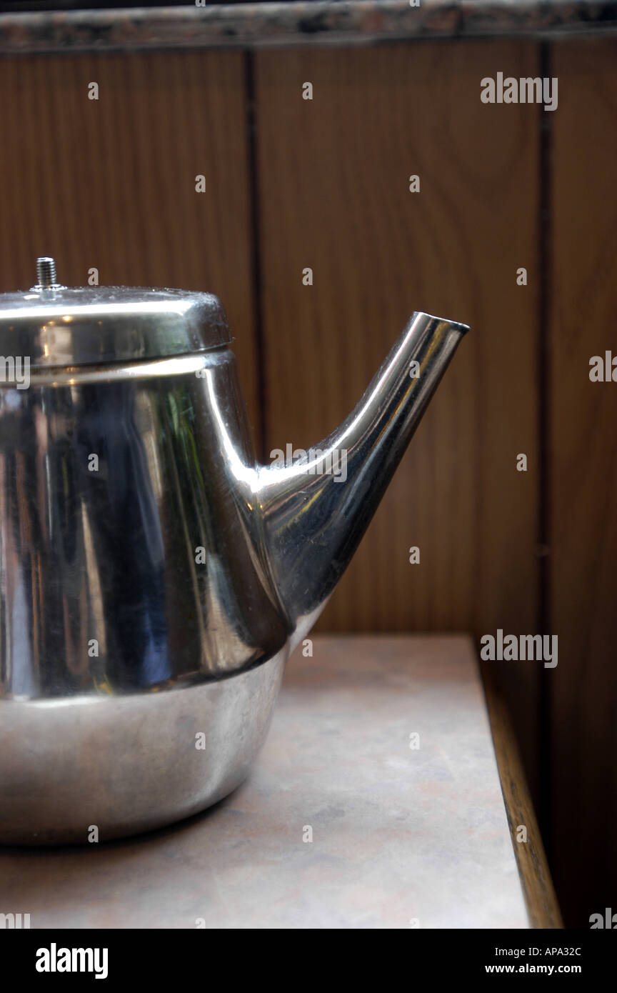 Silver teapot side and spout white table wood paneled bkgrnd Stock ...