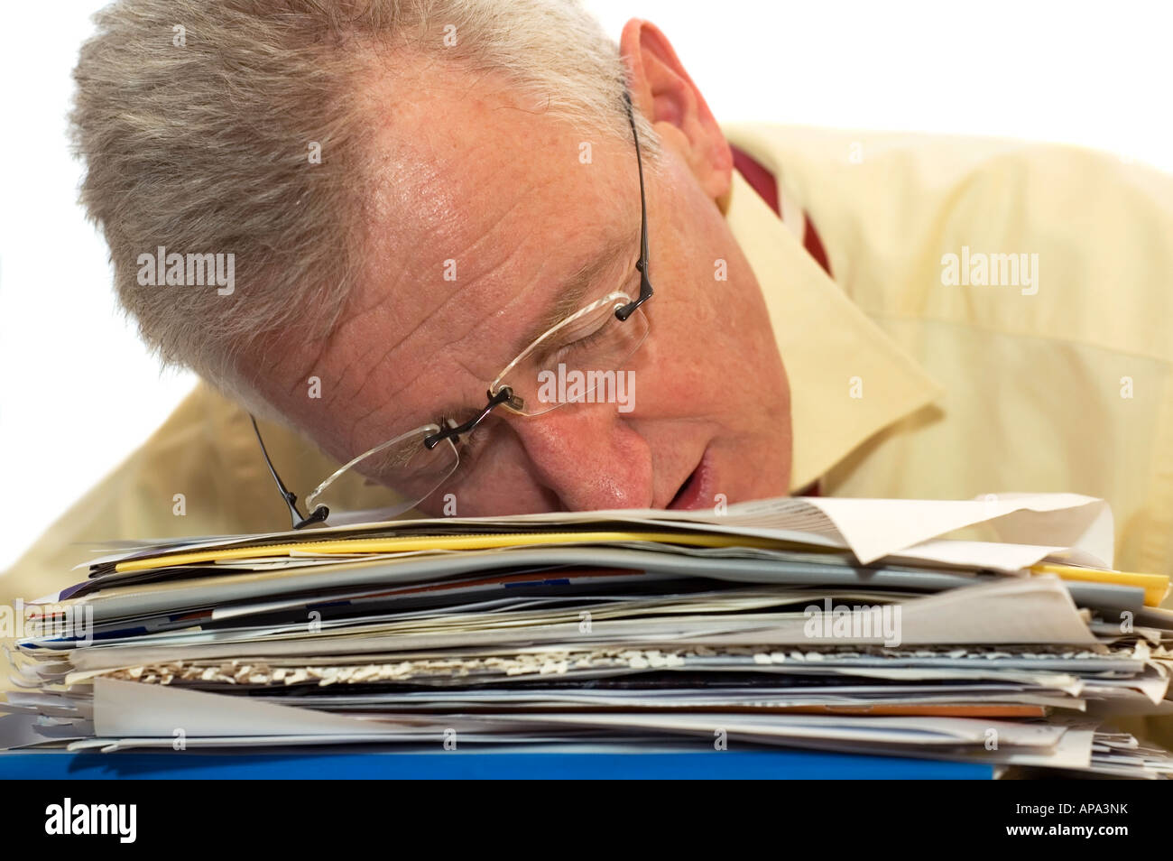 An exhausted senior businessman has fallen asleep on his work Stock ...