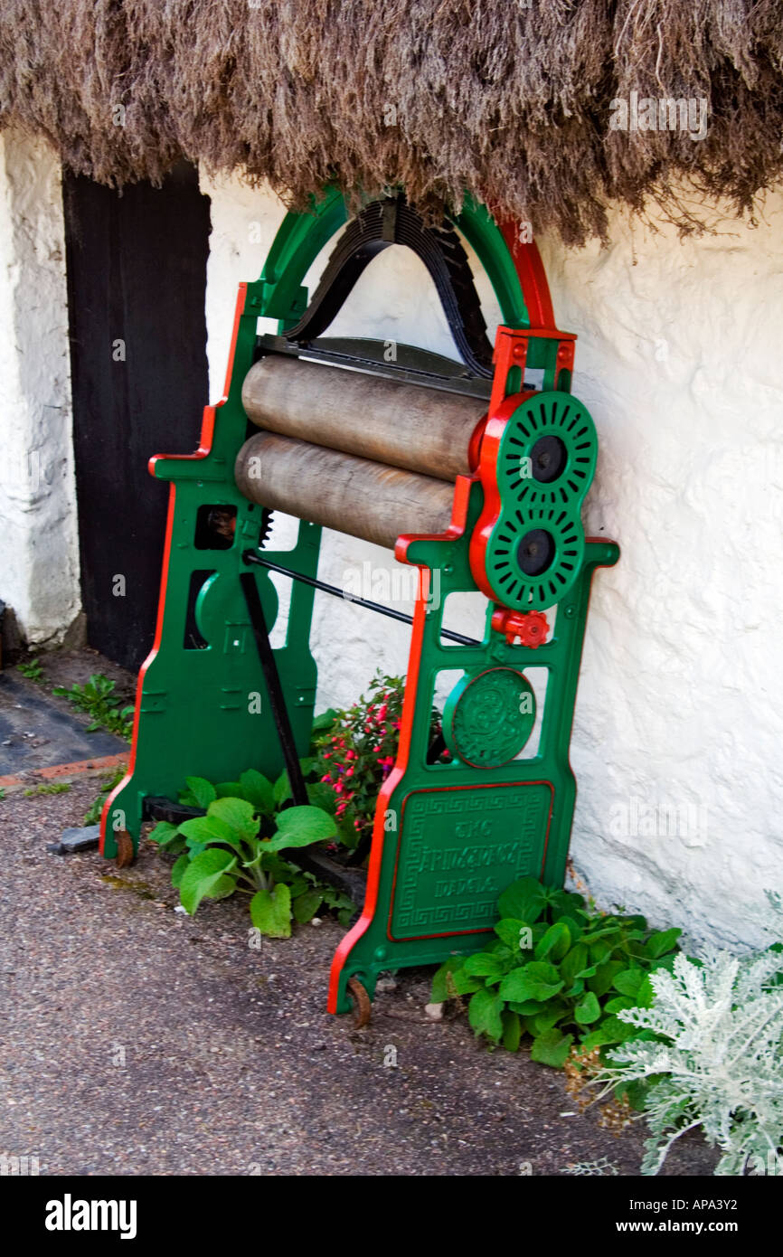 Old wringer leaning against a wall in Glencoe Village Scotland Stock ...
