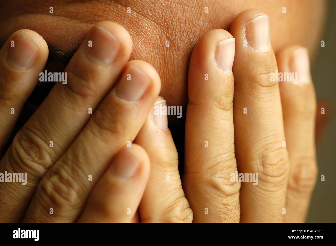 Close up both hands vertically over face Stock Photo - Alamy