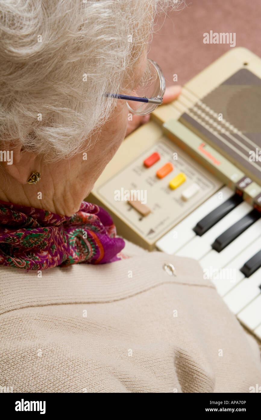 Elderly lady playing a keyboard Stock Photo - Alamy