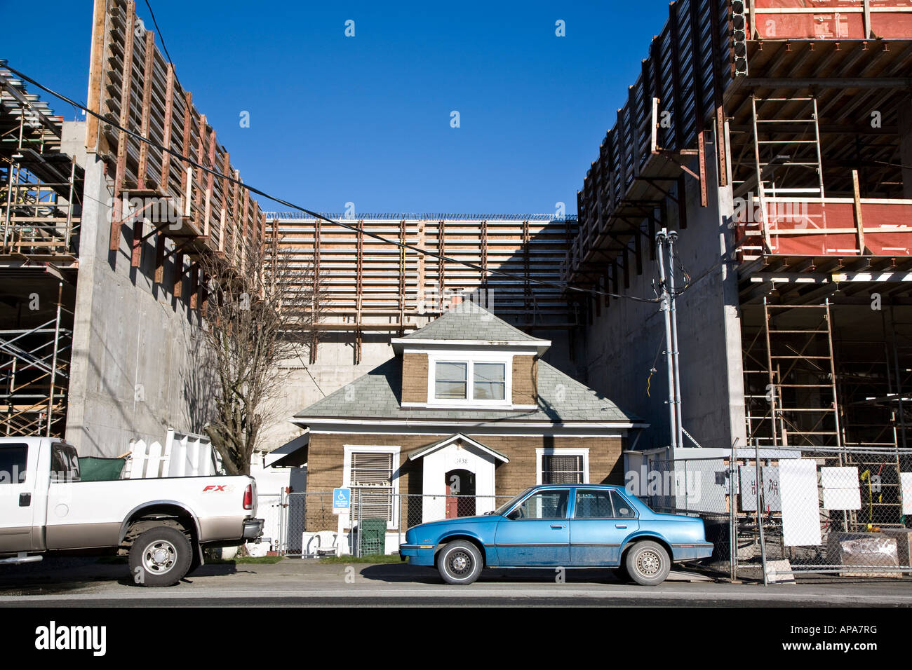 New construction around small old house Stock Photo - Alamy