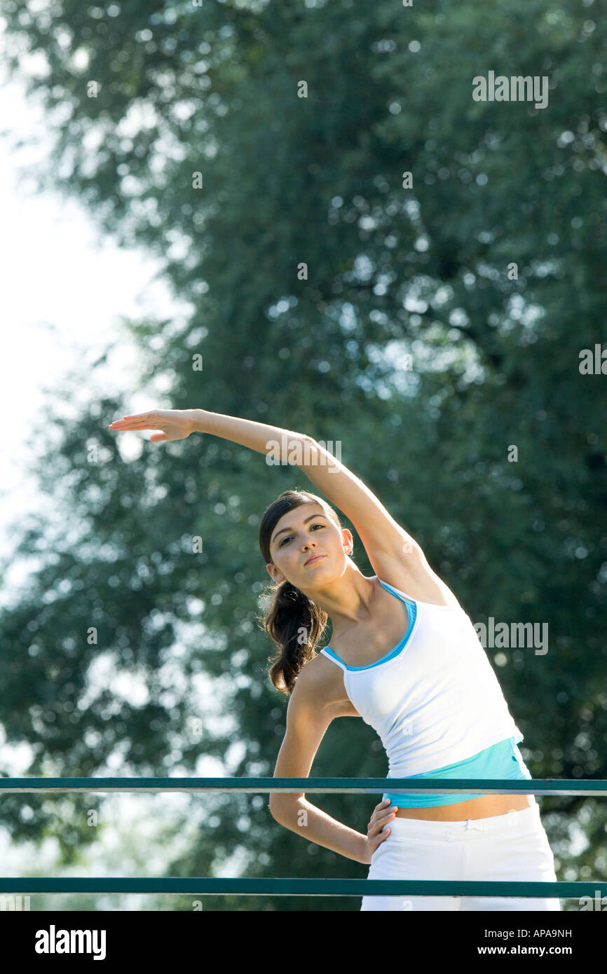Sportive young woman stretching railing hi-res stock photography and ...