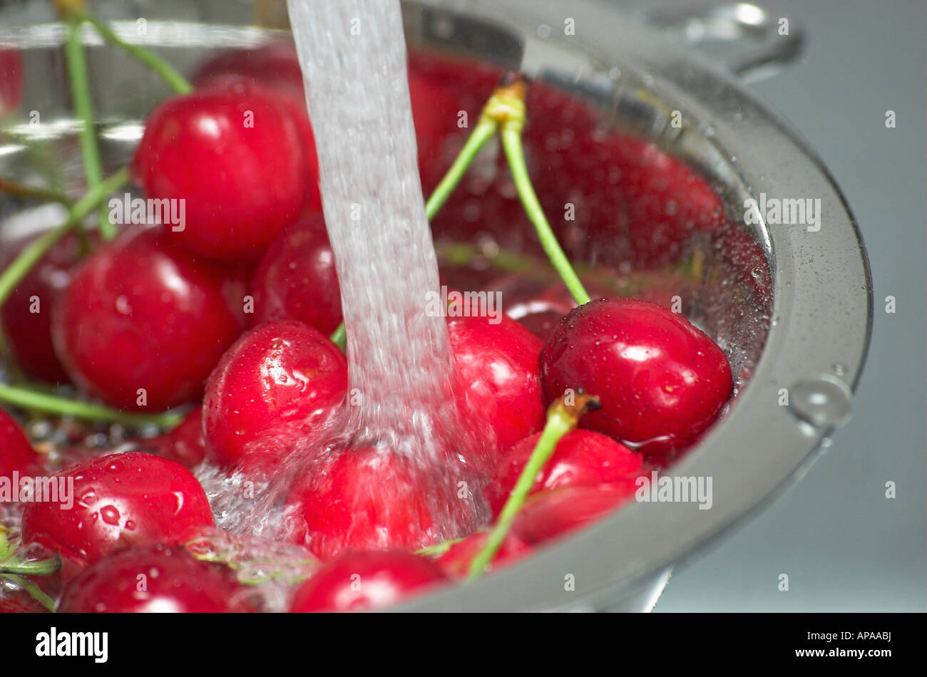 Water Pouring Over Cherries in a Metal Colander Stock Photo - Alamy