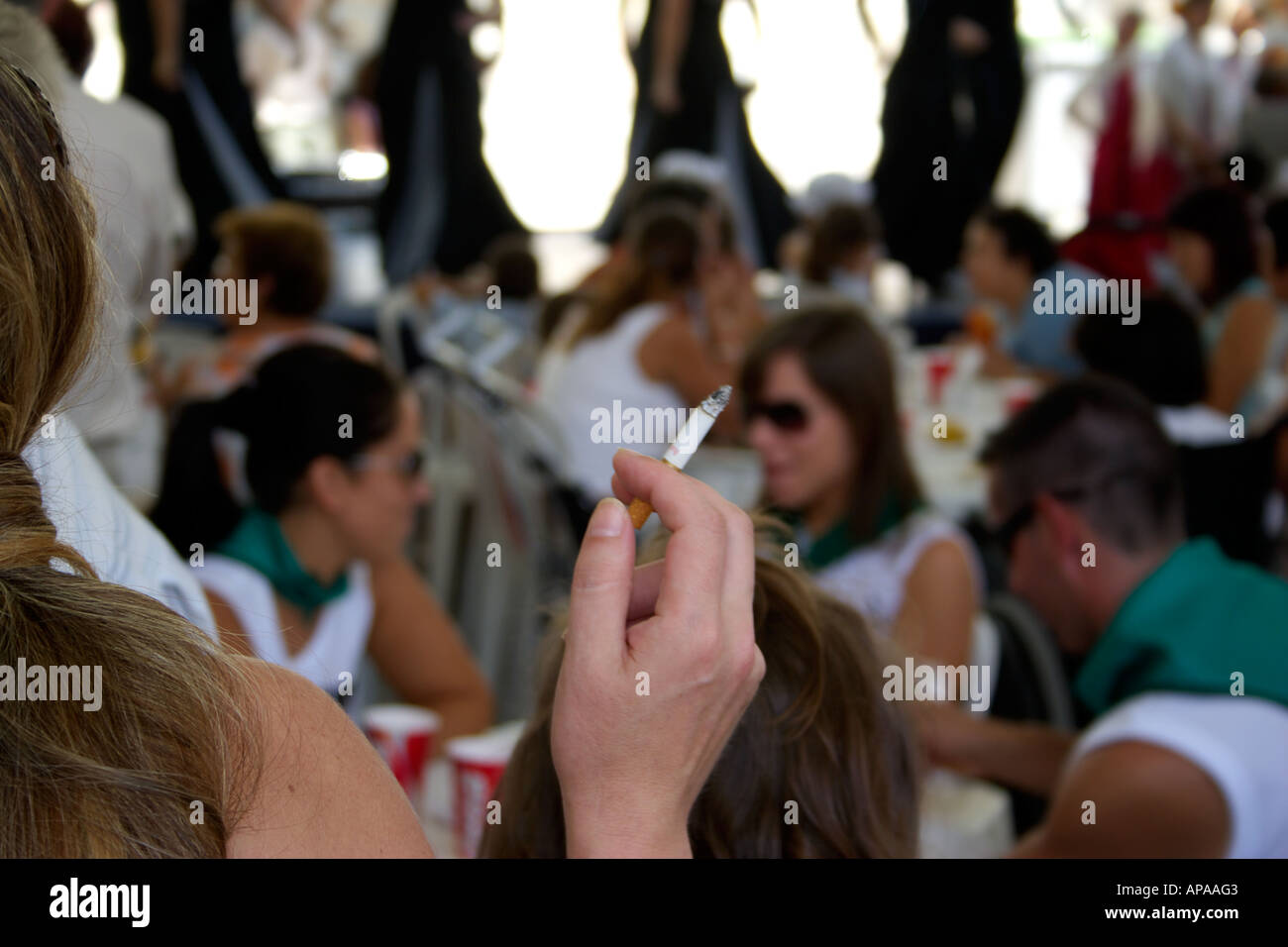 Cigarette smoking in a public place health issue Stock Photo - Alamy