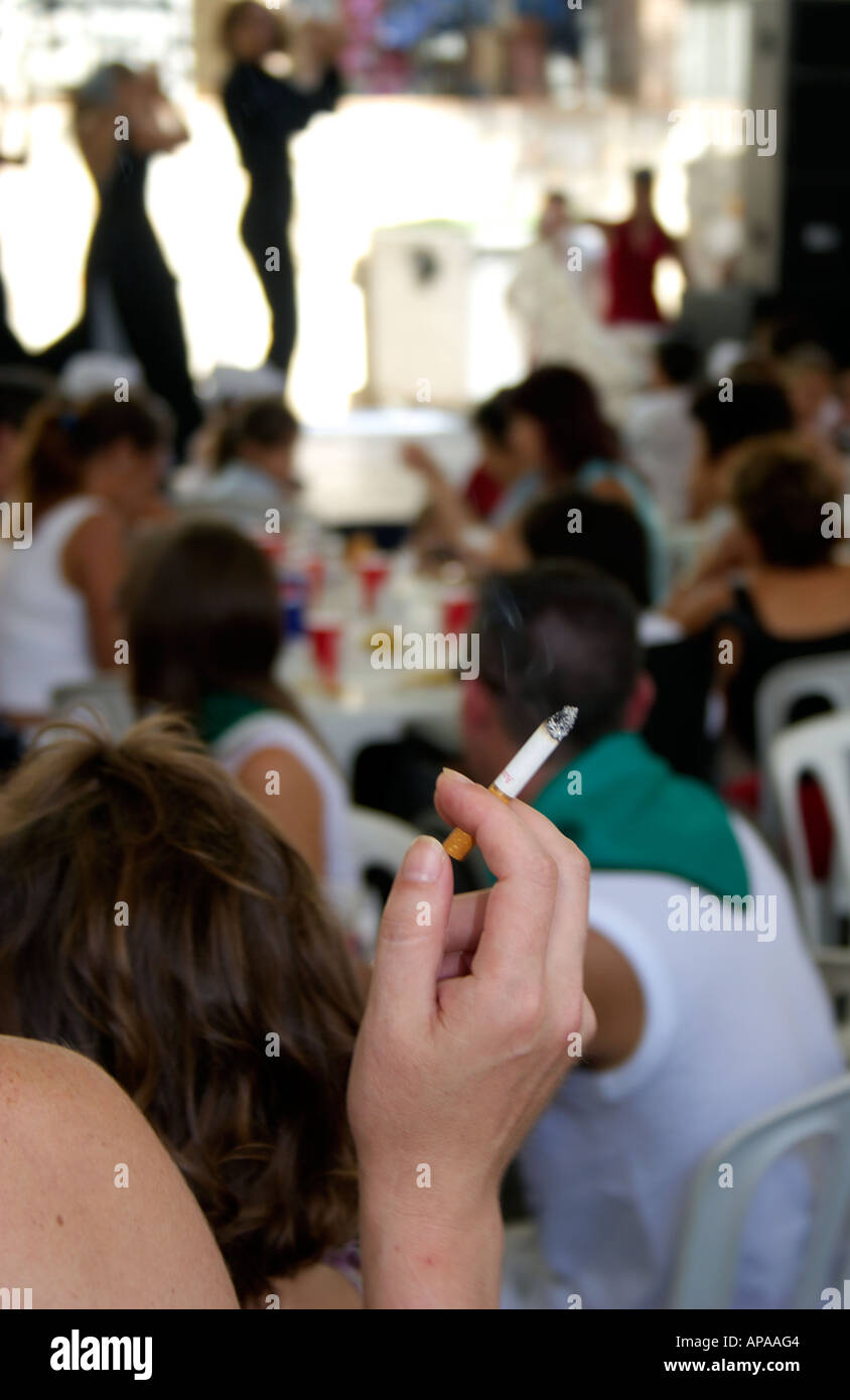 Cigarette smoking in a public place vertical Stock Photo - Alamy