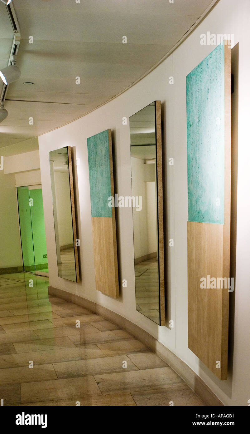 Paintings and mirrors on office wall Stock Photo - Alamy