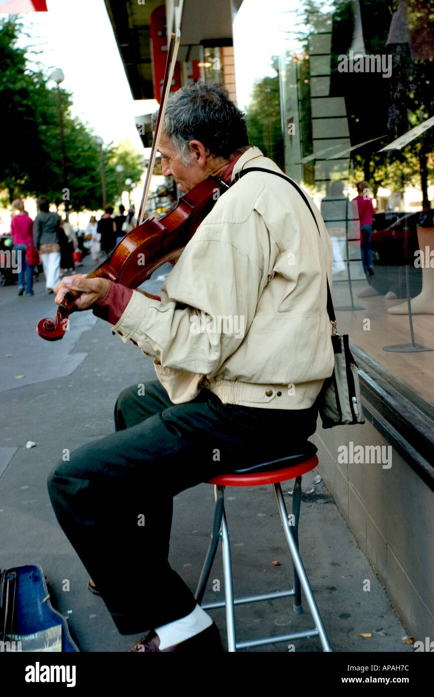 caucasian homeless on a chair man playing violin and begging for coins ...