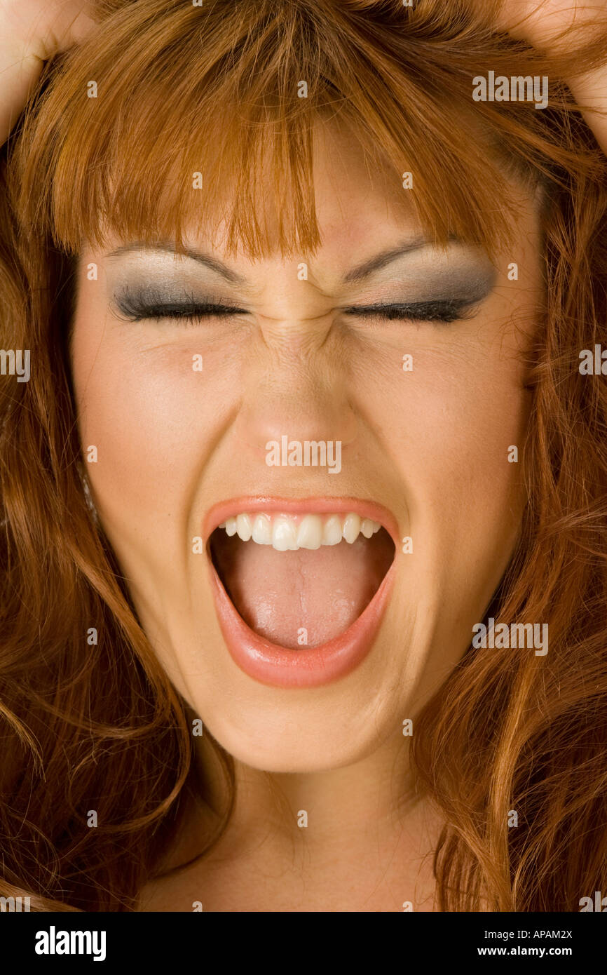 Beautiful redheaded woman screaming and pulling her hair Stock Photo ...