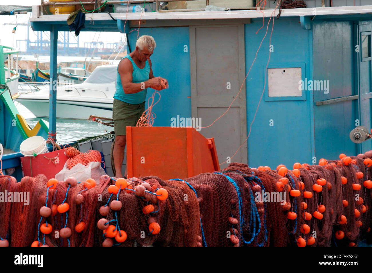 Net fishing mending hi-res stock photography and images - Alamy