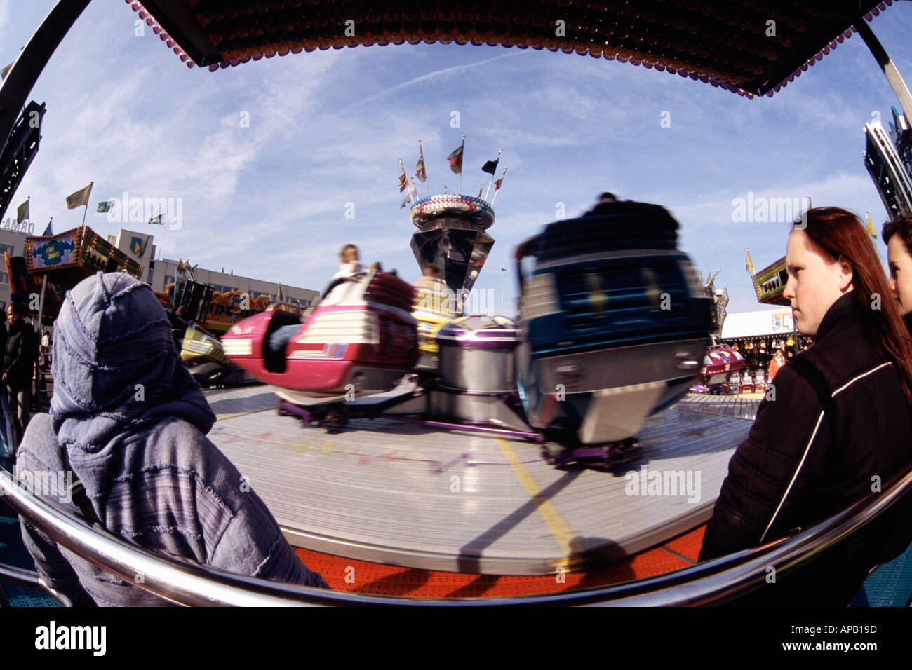 Fisheye image of people waiting for their turn in a spinning machine ...