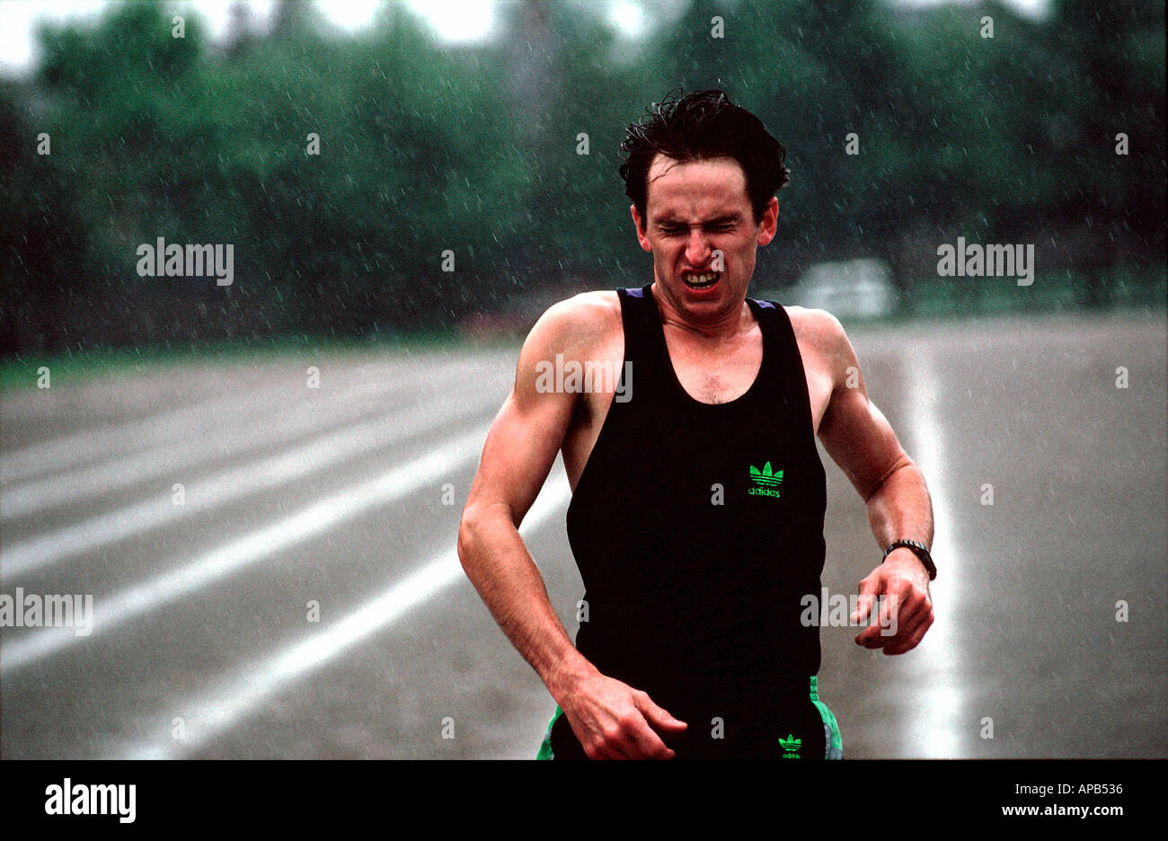 Runner in the rain Stock Photo - Alamy
