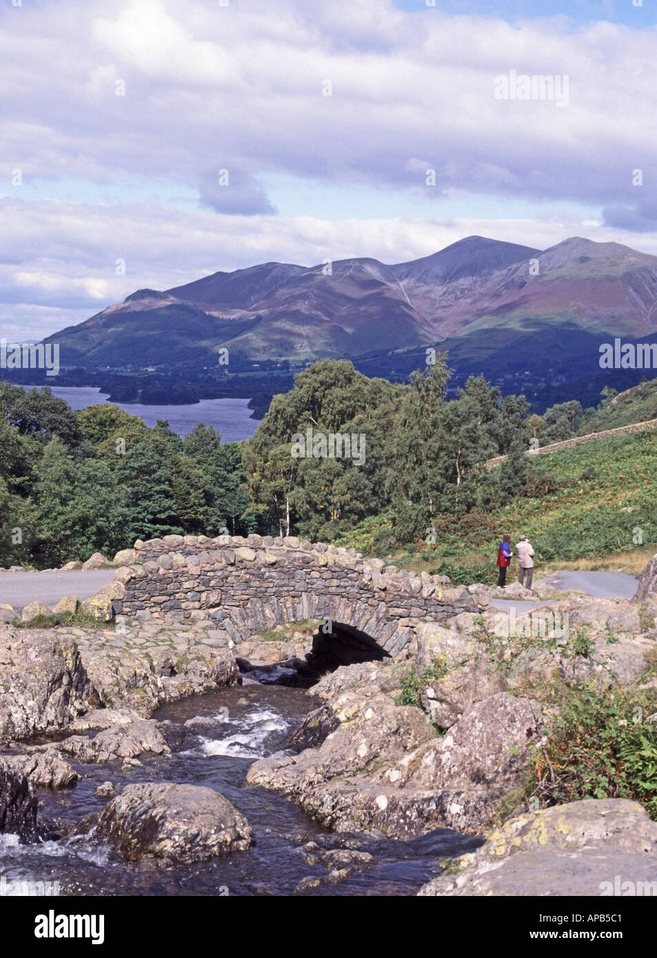 Historical sunny Ashness packhorse bridge walkers set off toward ...