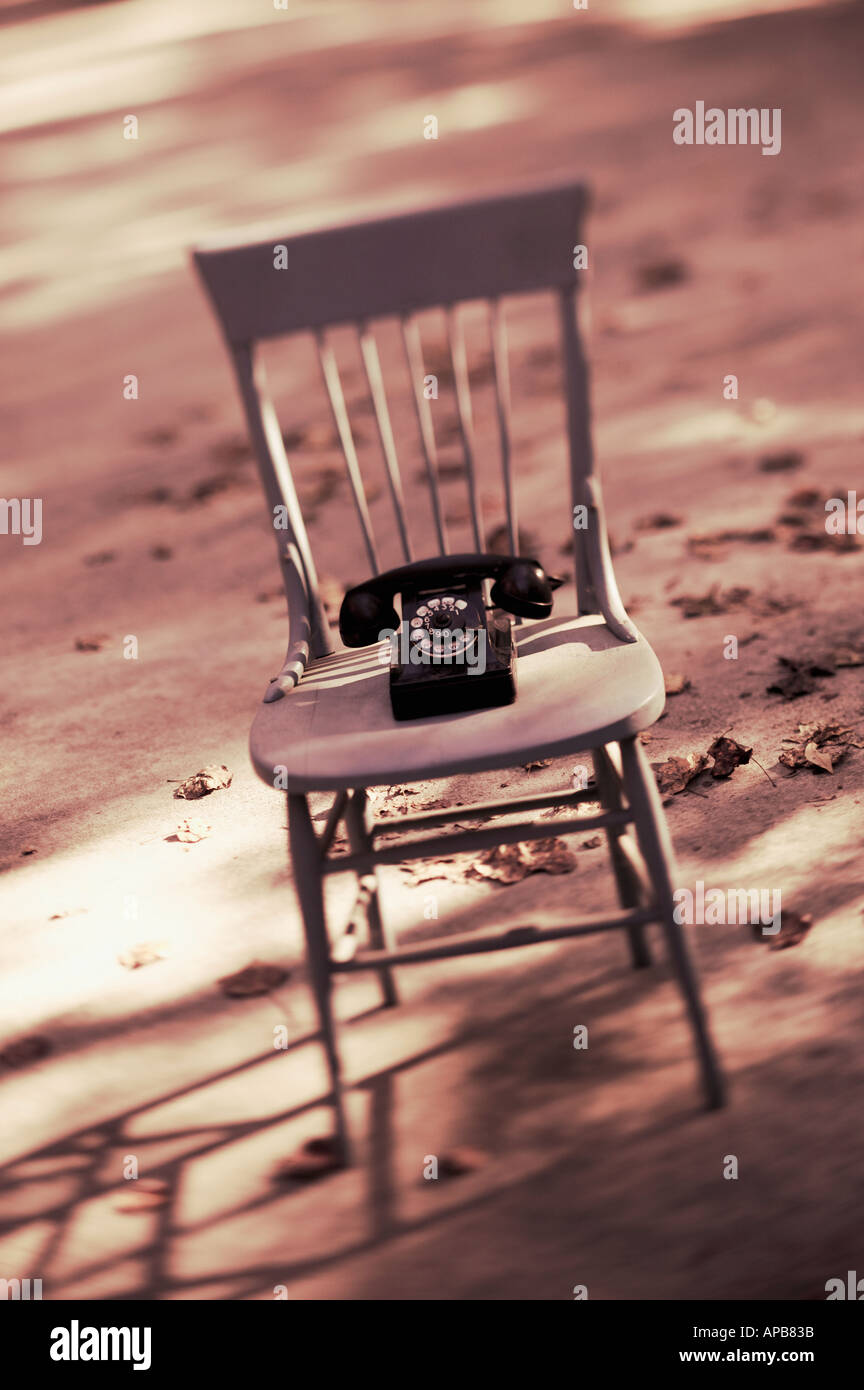 Antique telephone in a chair Stock Photo - Alamy