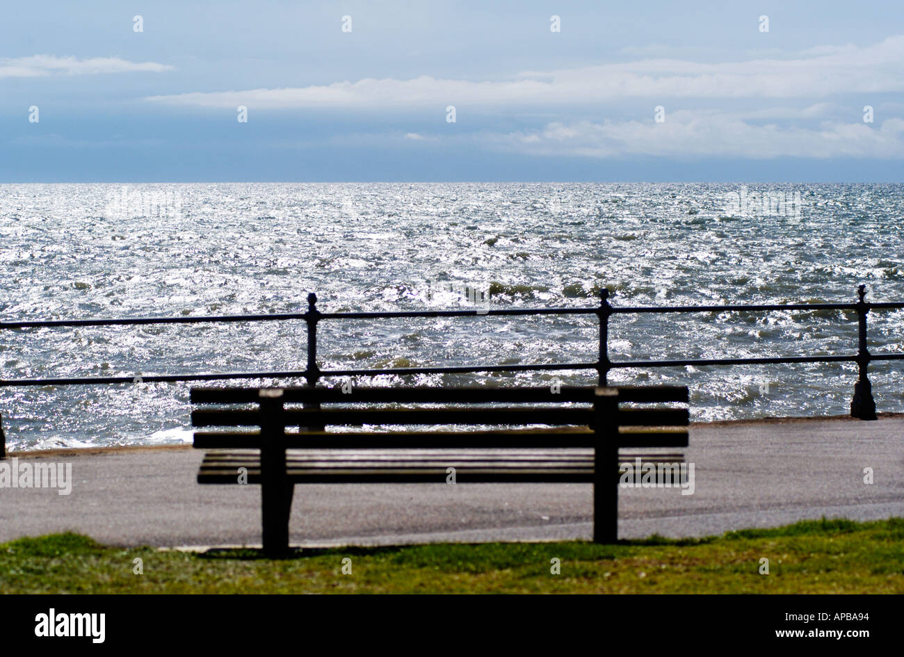 Bench on promenade overlooking sea Stock Photo - Alamy