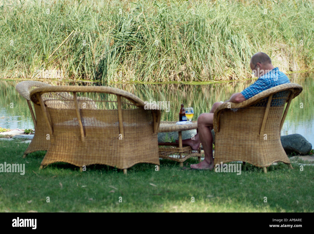 man sitting reading Stock Photo - Alamy