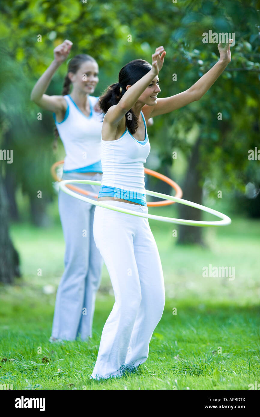 two young women with hoola hoops Stock Photo - Alamy