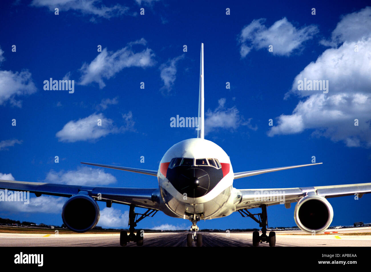 Commercial jet airliner on runway taking off Stock Photo - Alamy