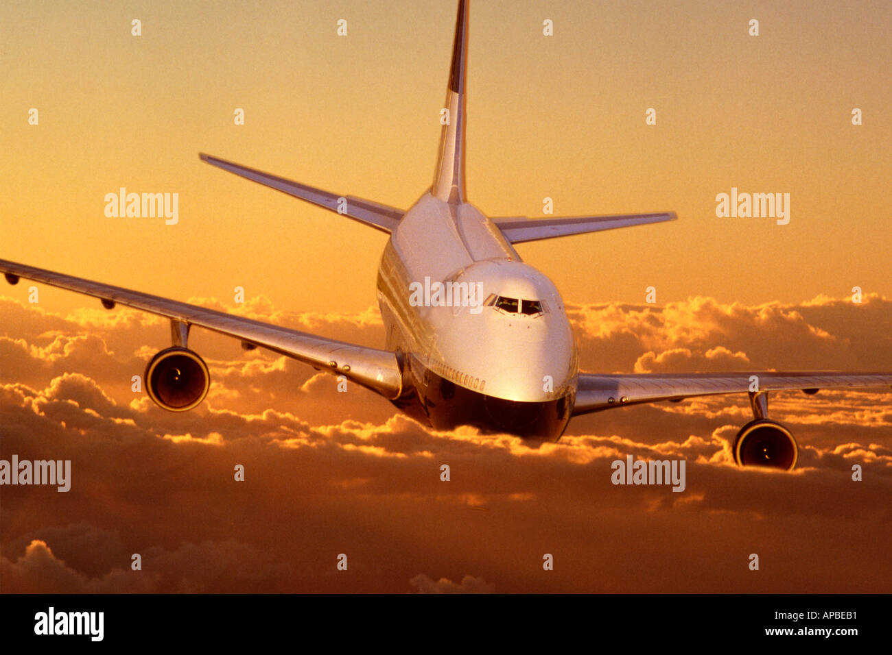 A 747 jumbo jet flying above the clouds at sunset Stock Photo - Alamy