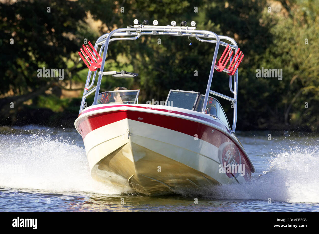 man driving a mastercraft x star wakeboard edition speed boat at speed ...