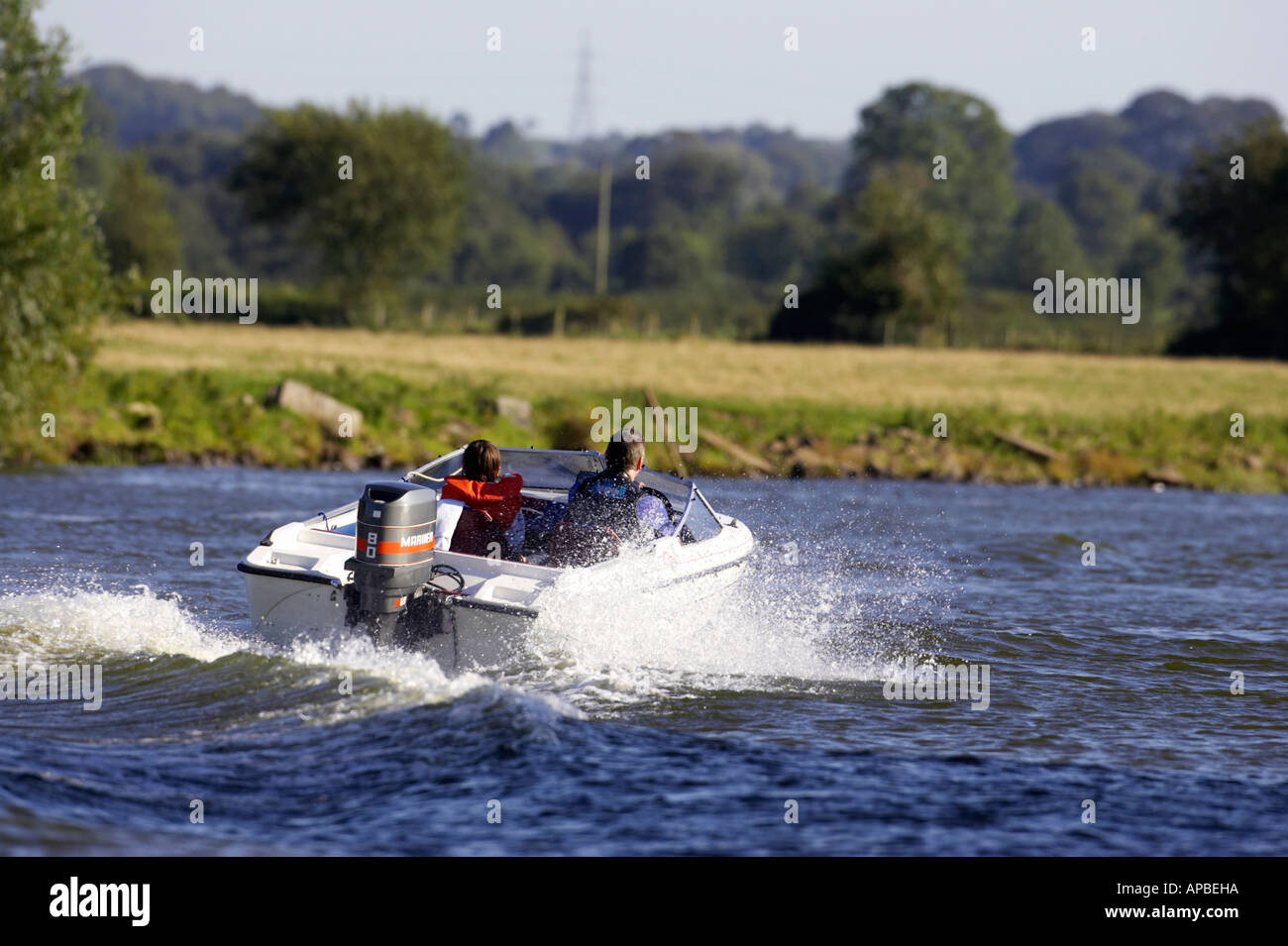 man with son in small powerboat speed boat with mariner 80 outboard ...