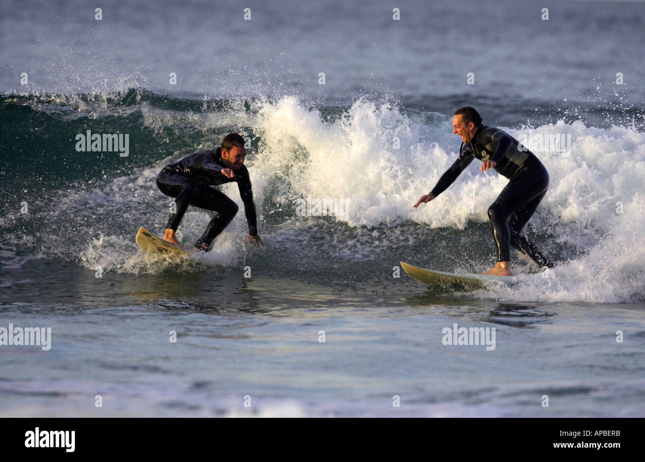 Two men wetsuits surfers hi-res stock photography and images - Alamy