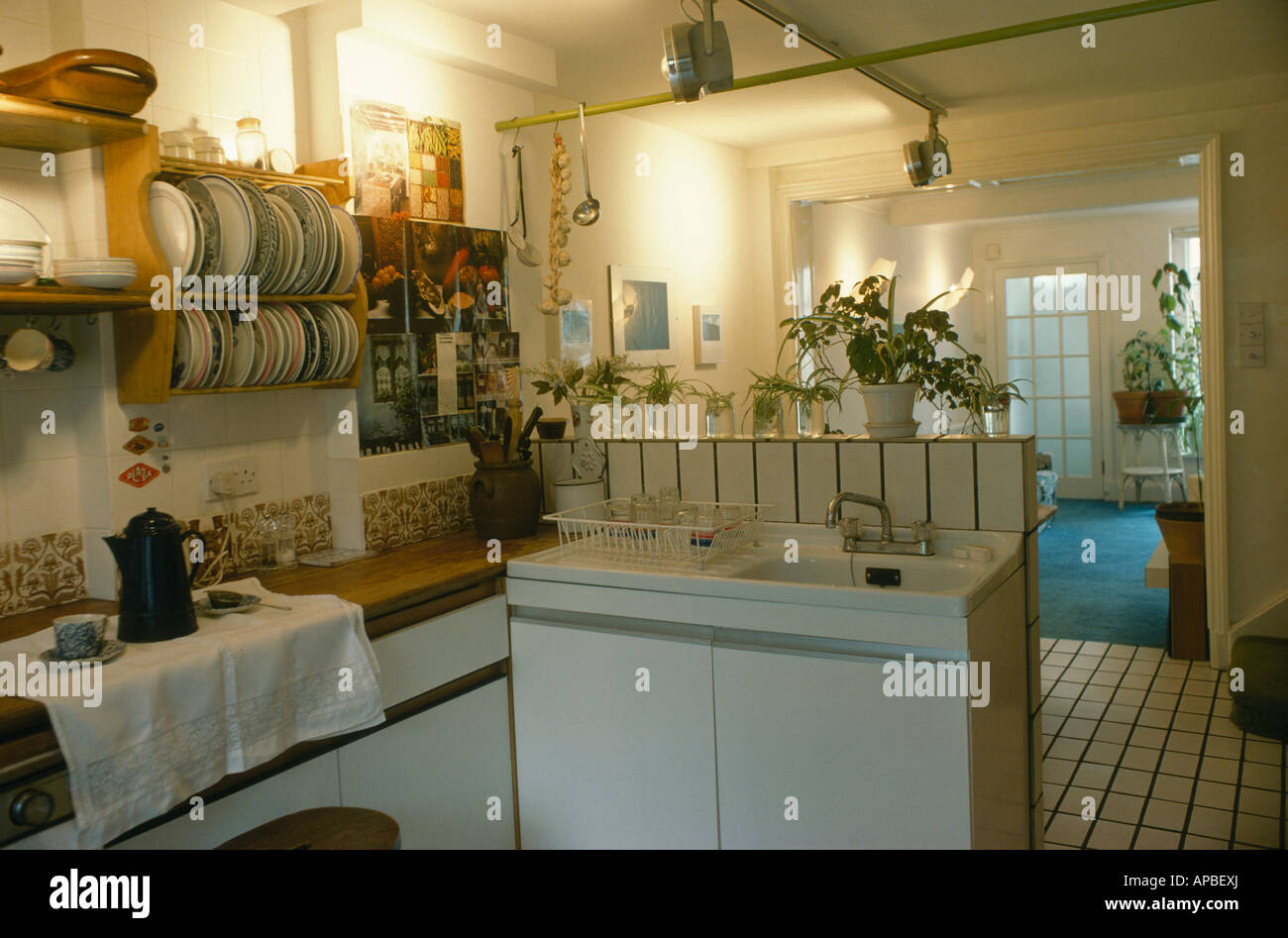 Lighting above sink in white sixties kitchen Stock Photo - Alamy