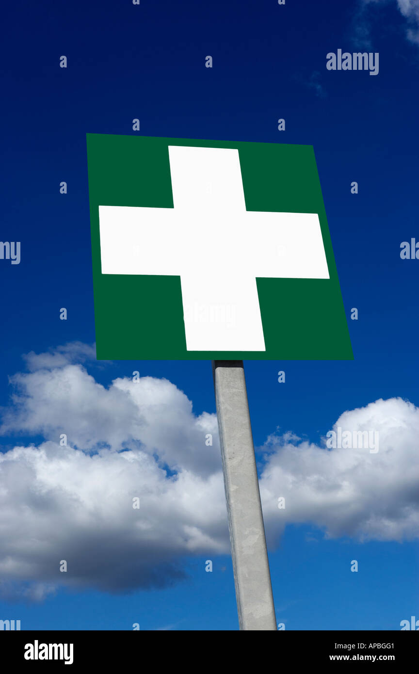 GREEN FIRST AID SIGN WITH WHITE CROSS AGAINST BLUE SKY BACKGROUND Stock ...
